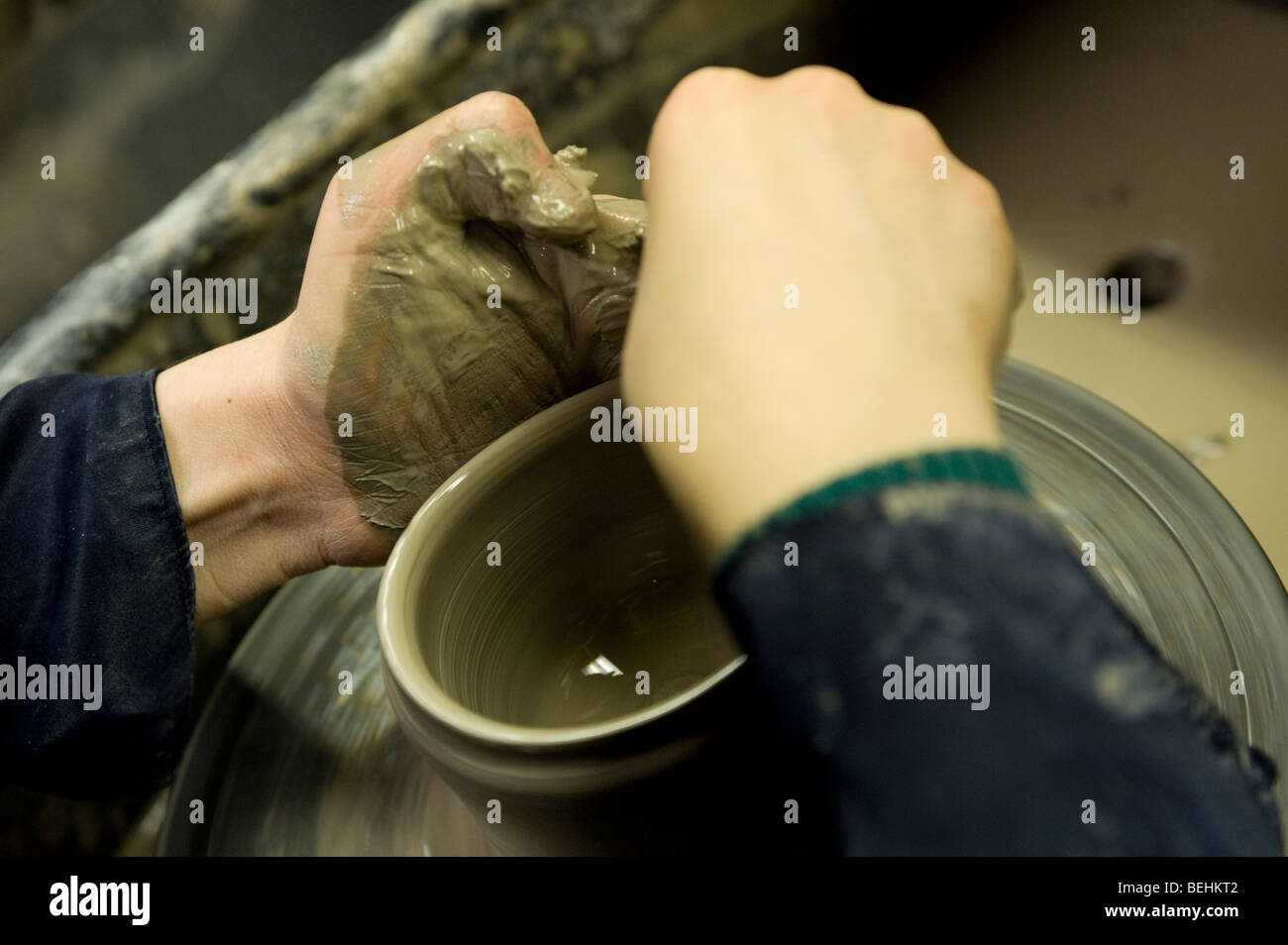 A potter moulding a pot at the spinning wheel Stock Photo - Alamy