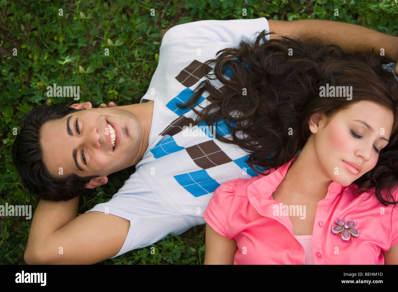 High angle view of a young couple lying in a park Stock Photo - Alamy