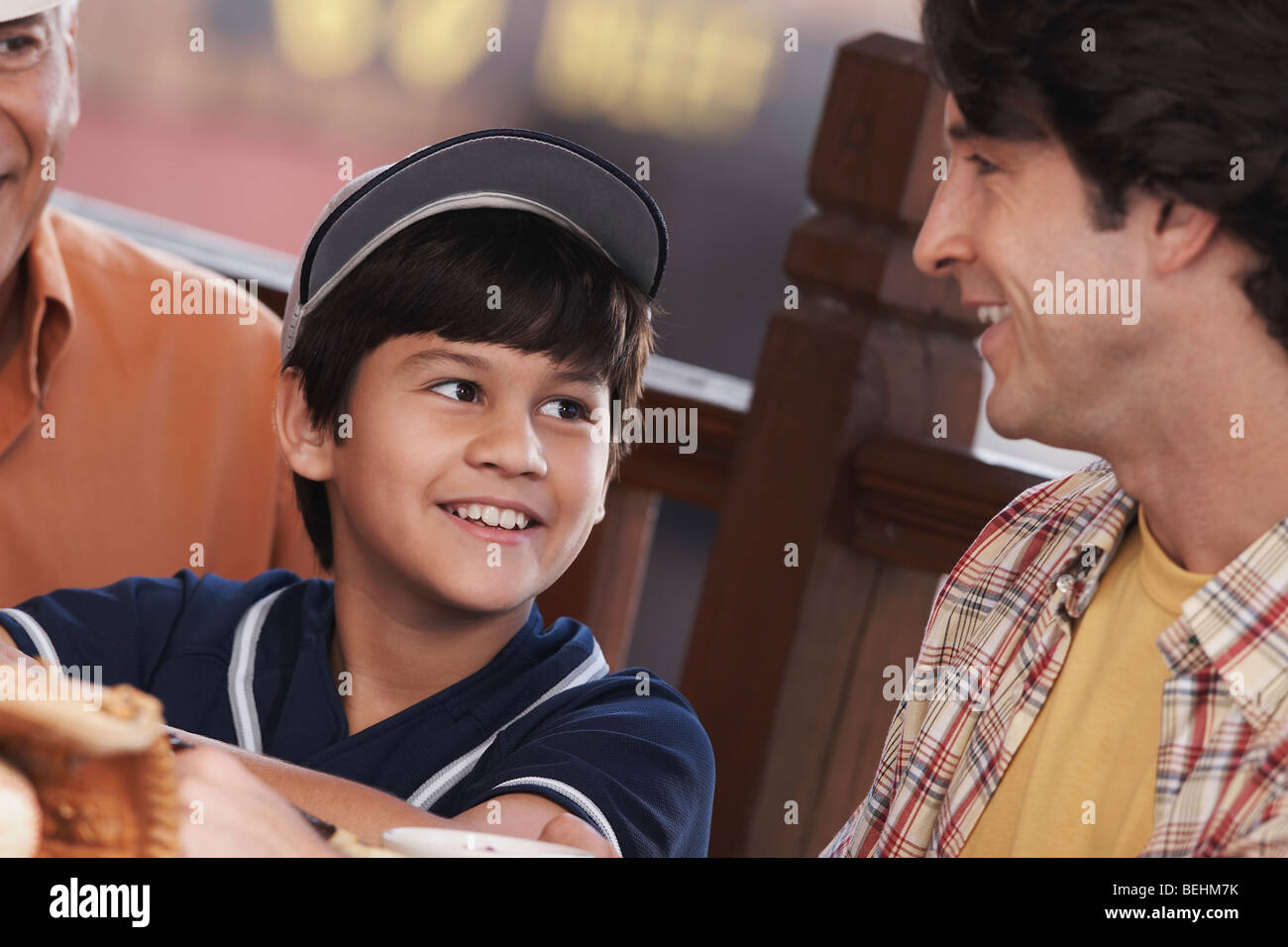 Close-up of a mid adult man with his son and father smiling Stock Photo ...