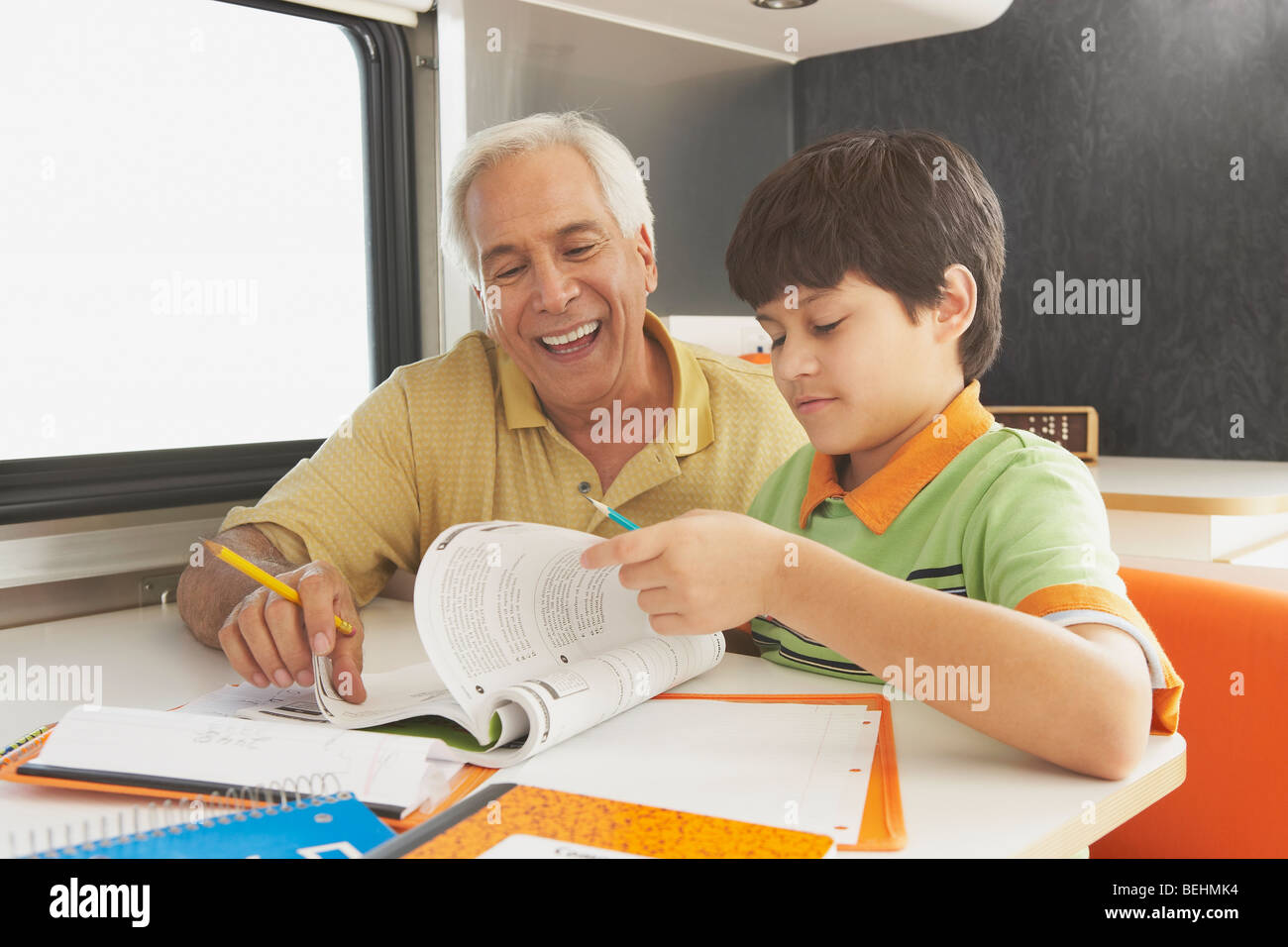 Senior man teaching his grandson and smiling Stock Photo - Alamy