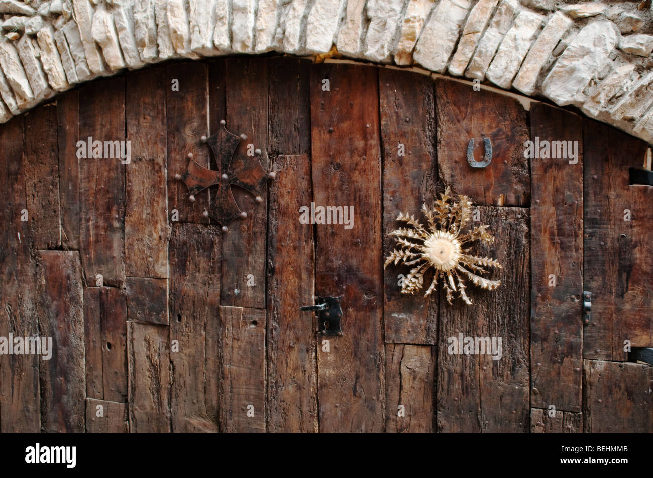 Occitan cross and Cardabelle flower on the old door, Saint-Guilhem-le ...