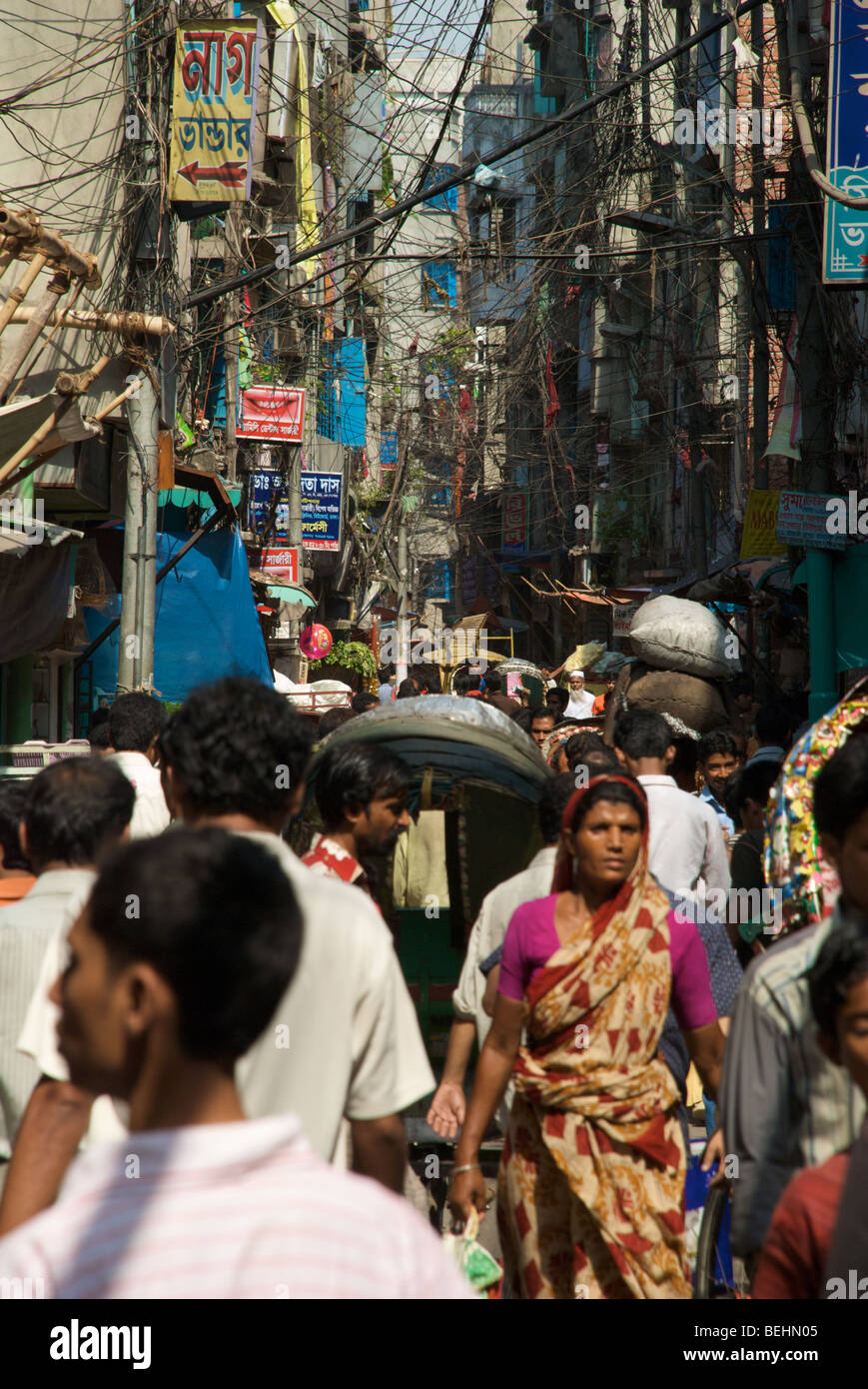 A Crowded alley way in Dhaka, Bangladesh with a ceiling of web of ...