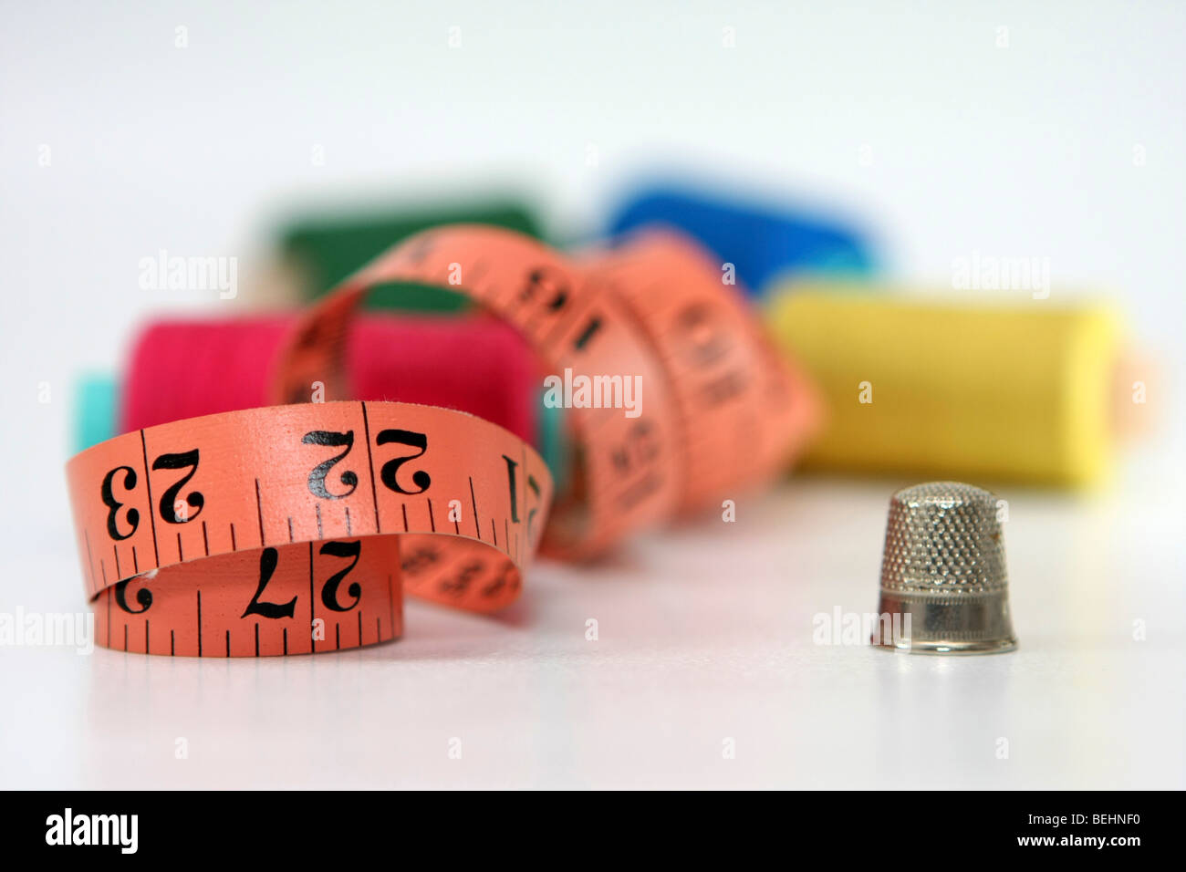 Sewing kit thread, thimble and measuring tape Stock Photo - Alamy
