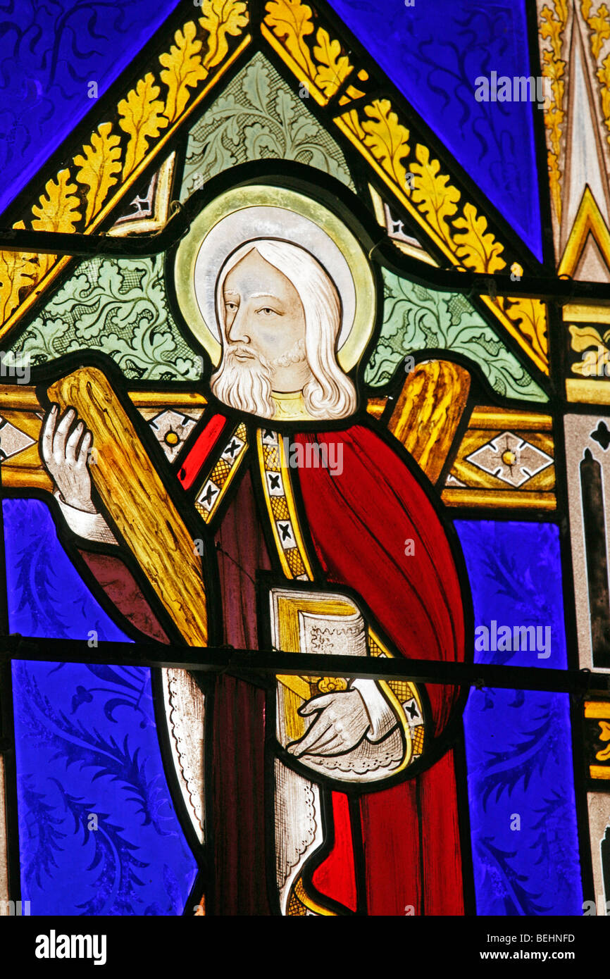 A stained glass window depicting St Andrew the Apostle holding a wooden ...