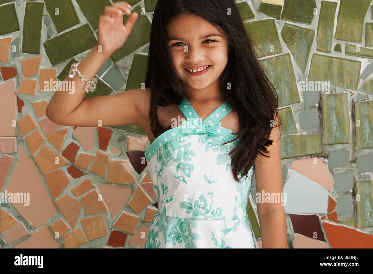 Portrait of a girl raising her hand Stock Photo - Alamy