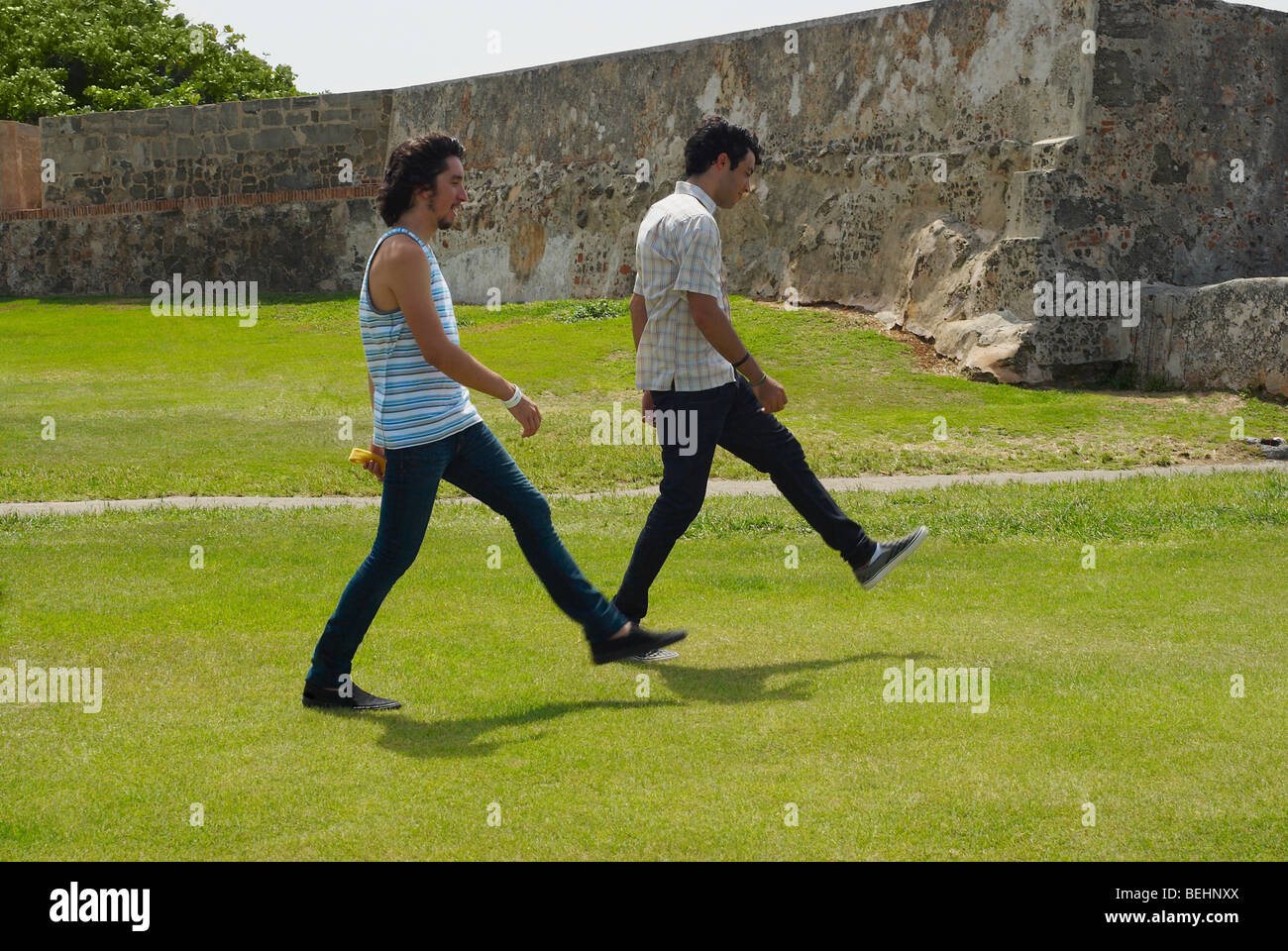 Side profile of two young men walking in a park Stock Photo - Alamy