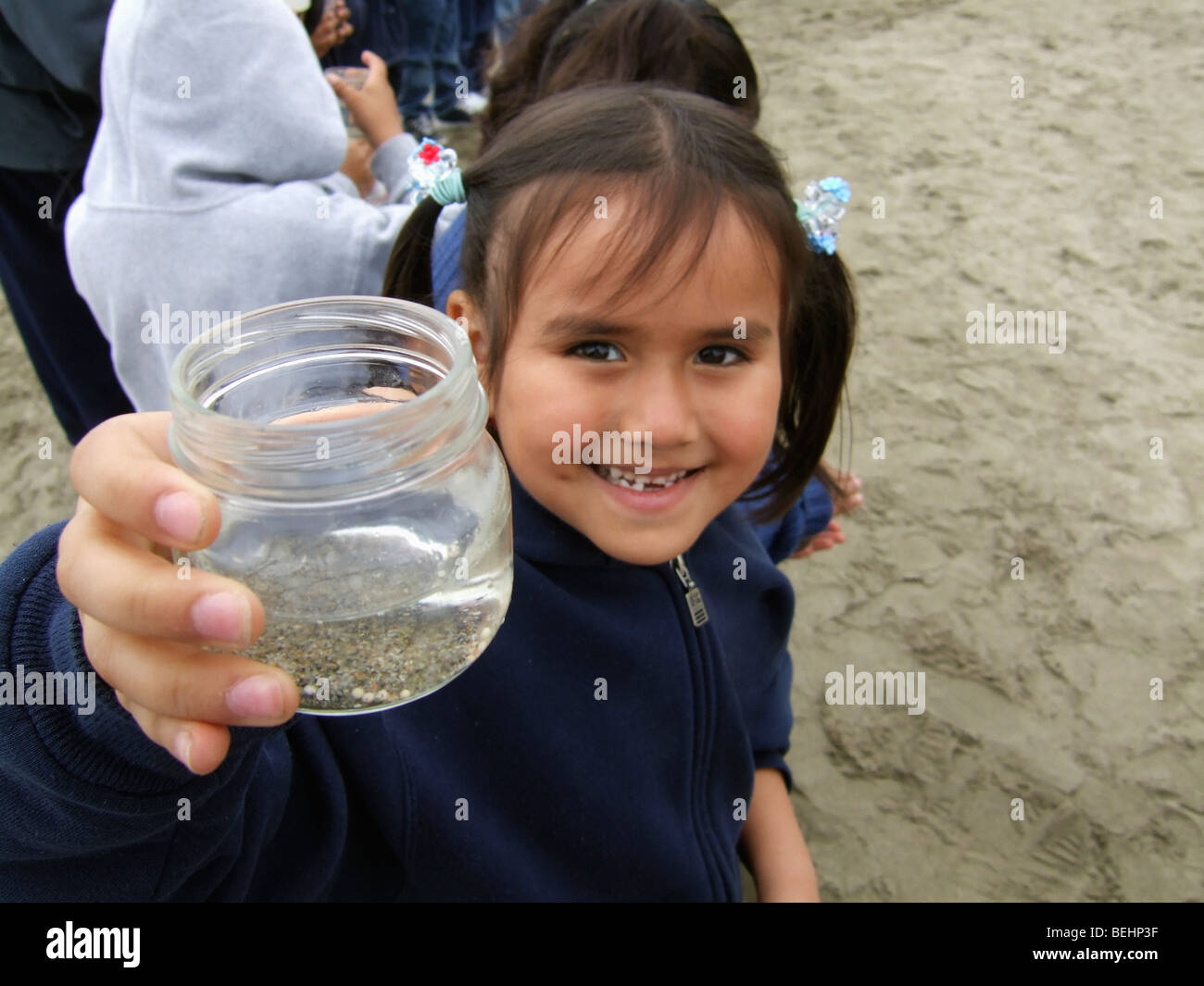 Girl showing jar on field trip Stock Photo - Alamy