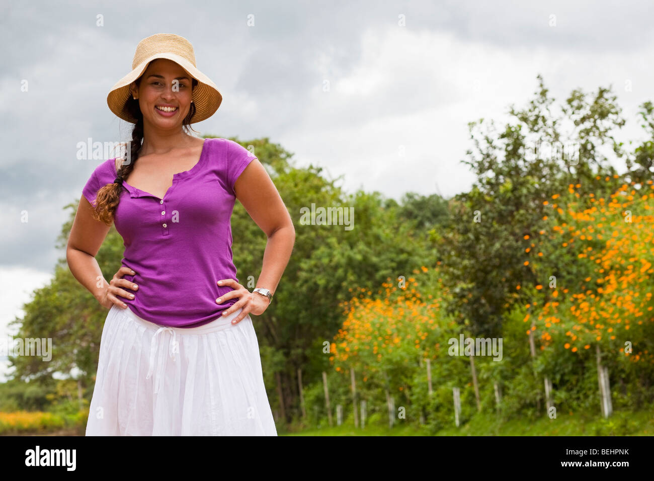 Confident woman standing arms akimbo hi-res stock photography and ...