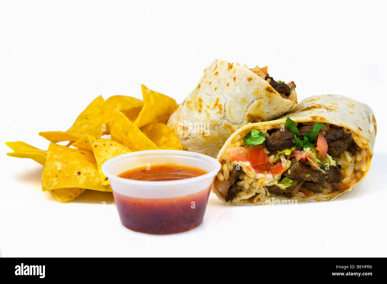 Close-up of a burrito with nachos and salsa Stock Photo - Alamy