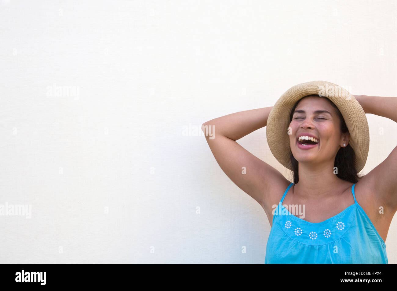 Woman laughing with her hands behind her head Stock Photo - Alamy