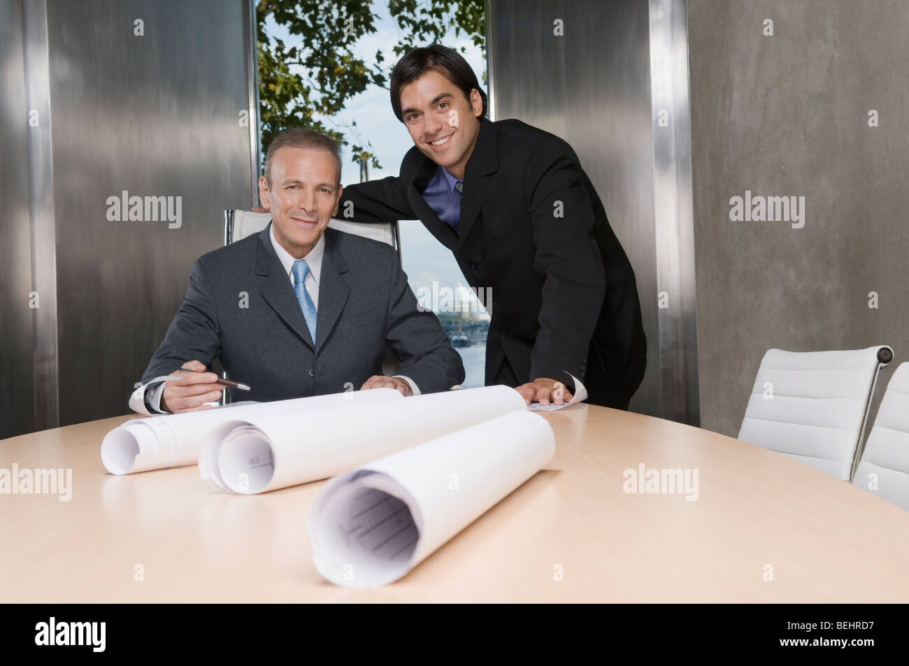 Two businessmen smiling in a conference room Stock Photo - Alamy