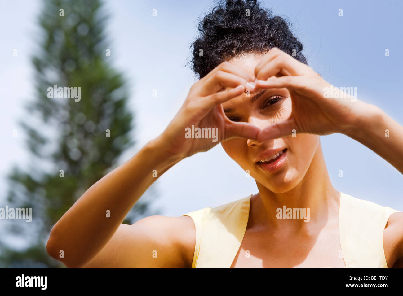 Woman making heart shape with her hands in front of her face Stock ...
