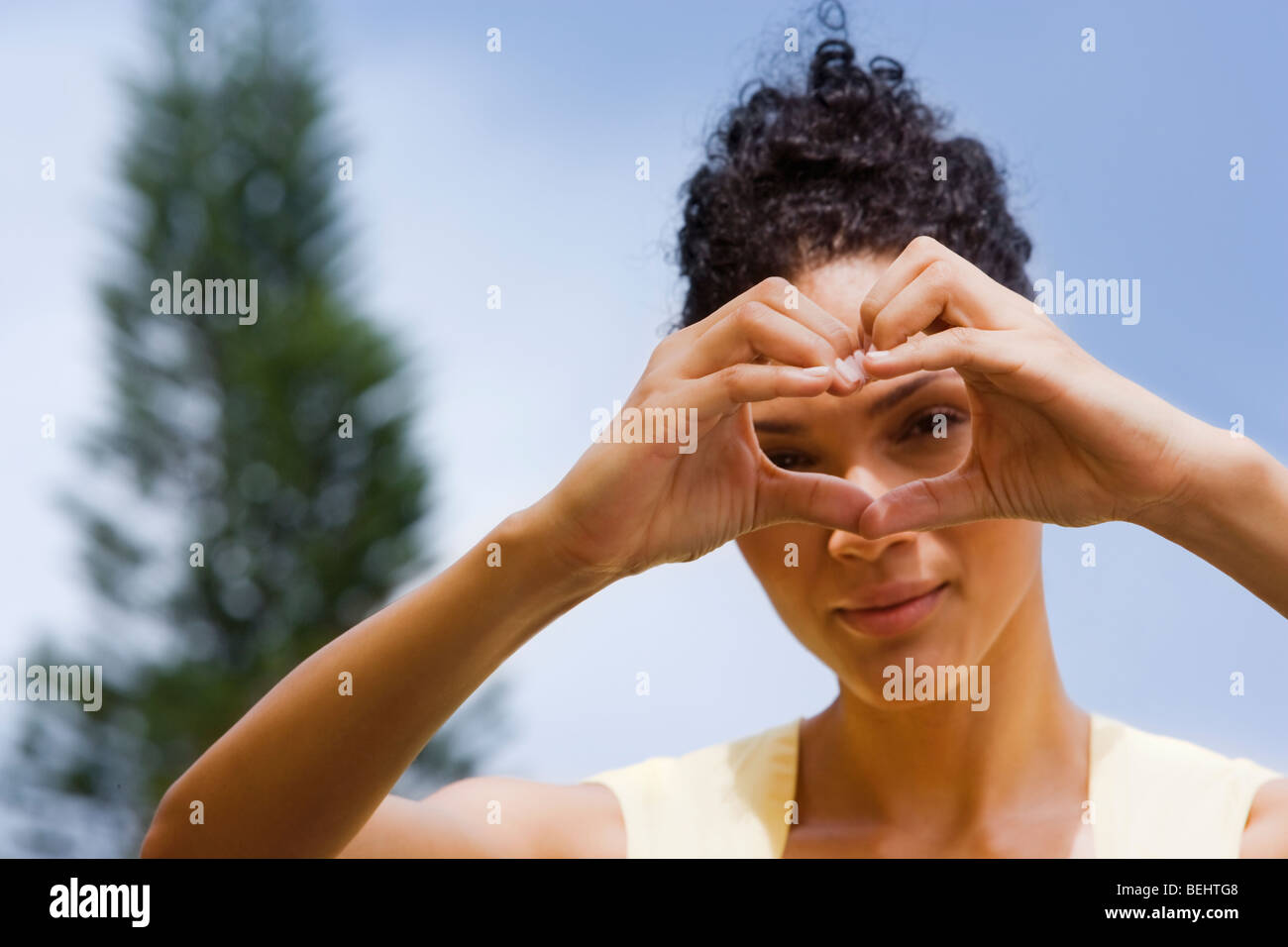 Woman making heart shape with her hands in front of her face Stock ...