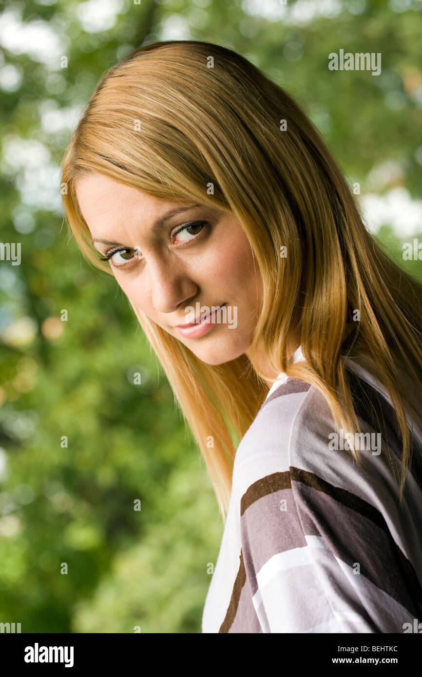 Young woman looking back, over the shoulder Stock Photo - Alamy