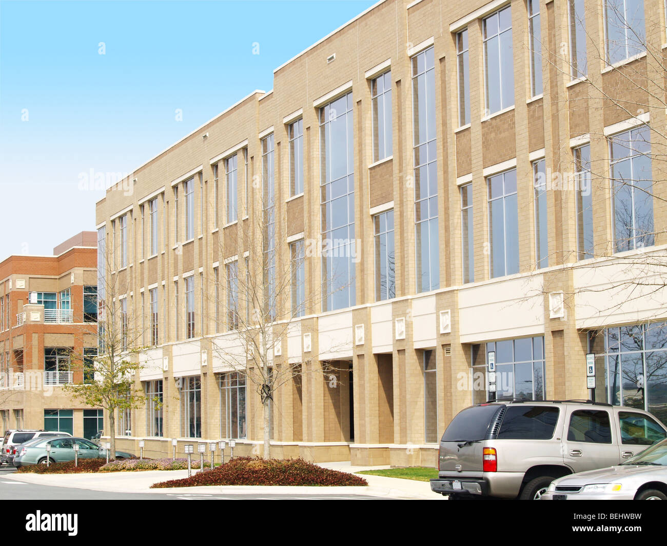 Large corporate building with cars parked out front Stock Photo - Alamy
