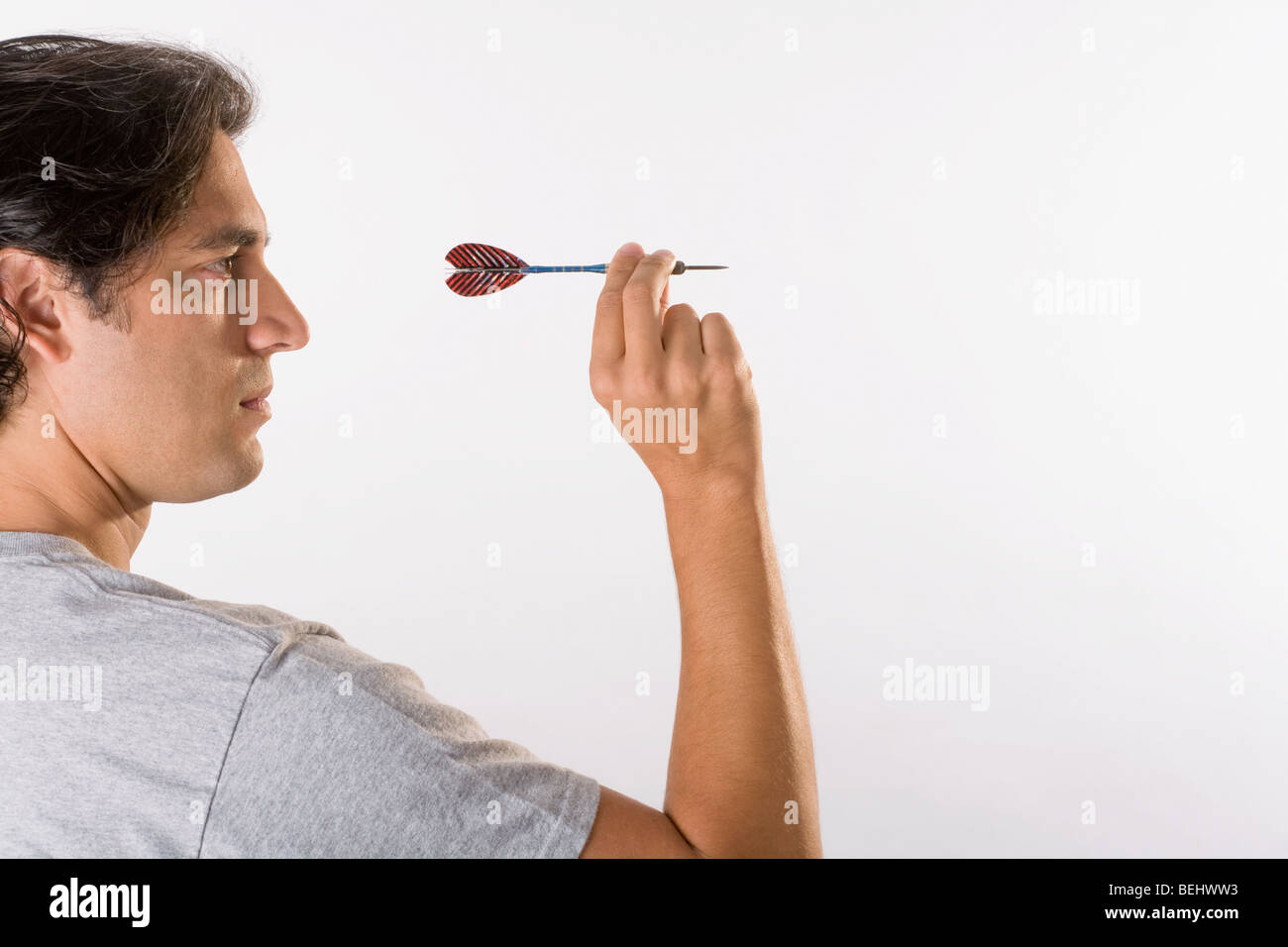 Man playing darts Stock Photo - Alamy