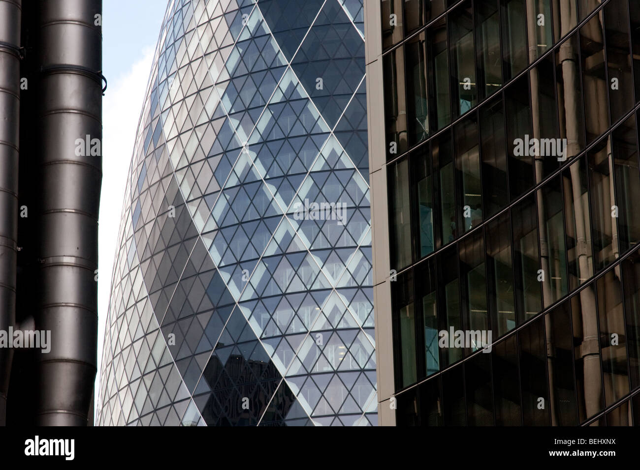 Swiss Re Gherkin building viewed from between surrounding buildings ...