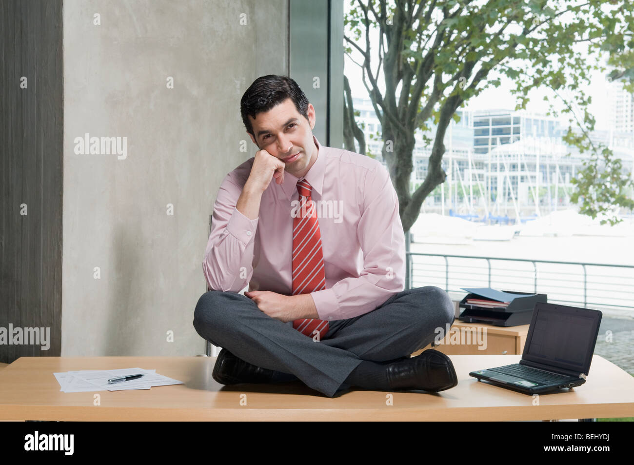 Executive sitting with elbows on desk hi-res stock photography and ...