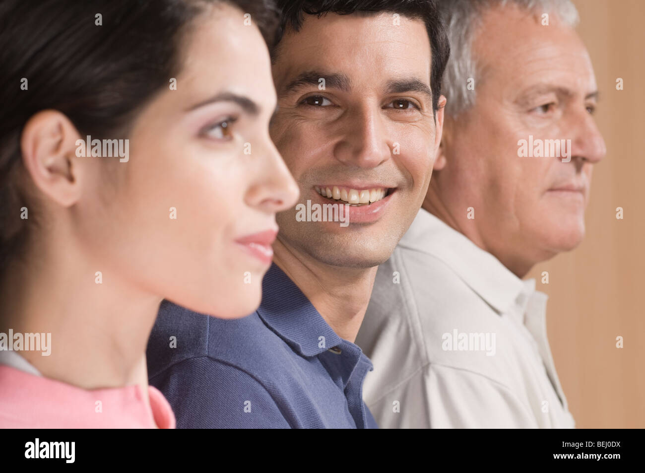 Man smiling with his family beside him Stock Photo - Alamy
