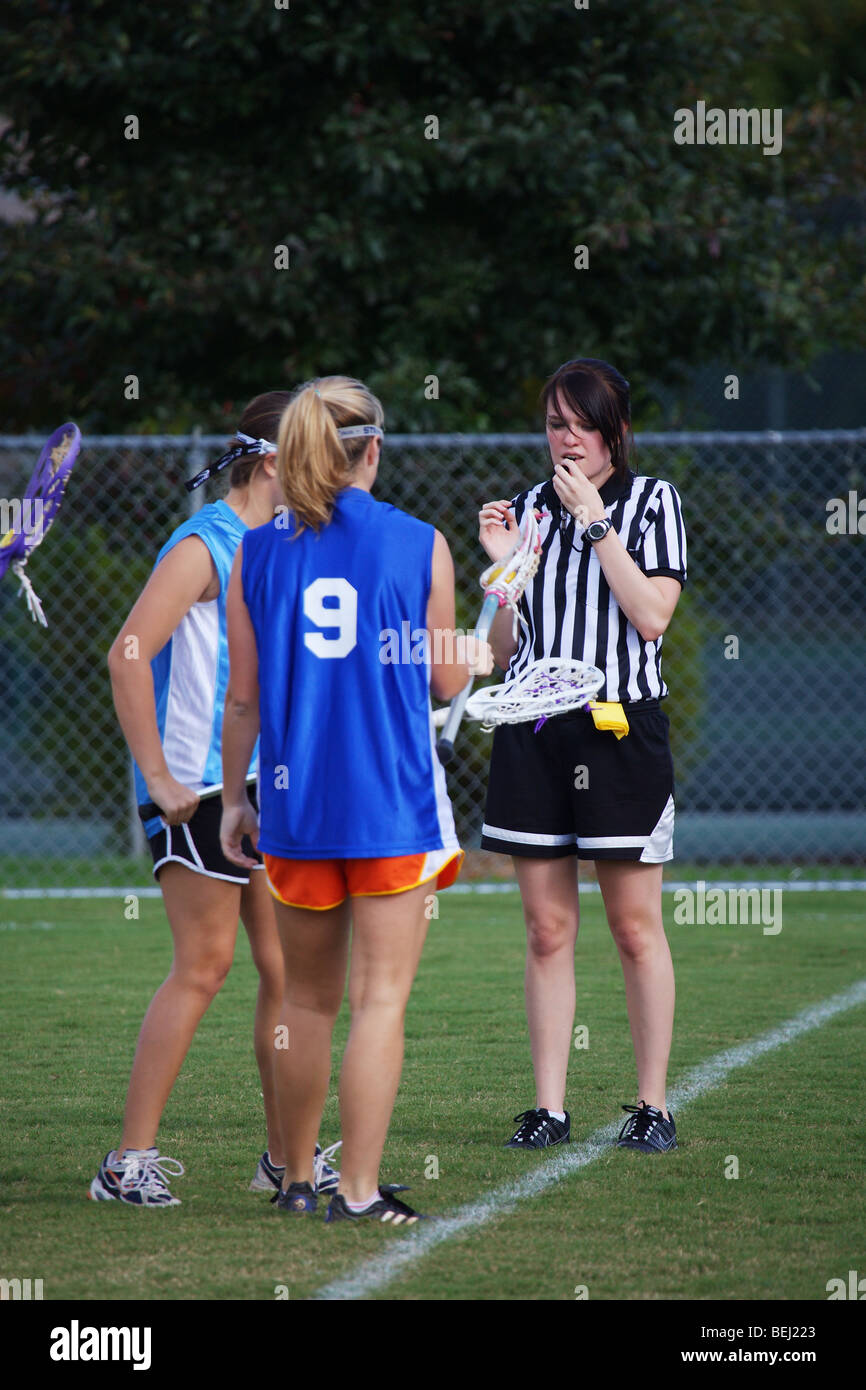 FEMALE REFEREE INITIATES A FACE OFF HIGH SCHOOL GIRLS LACROSSE AMBER ...