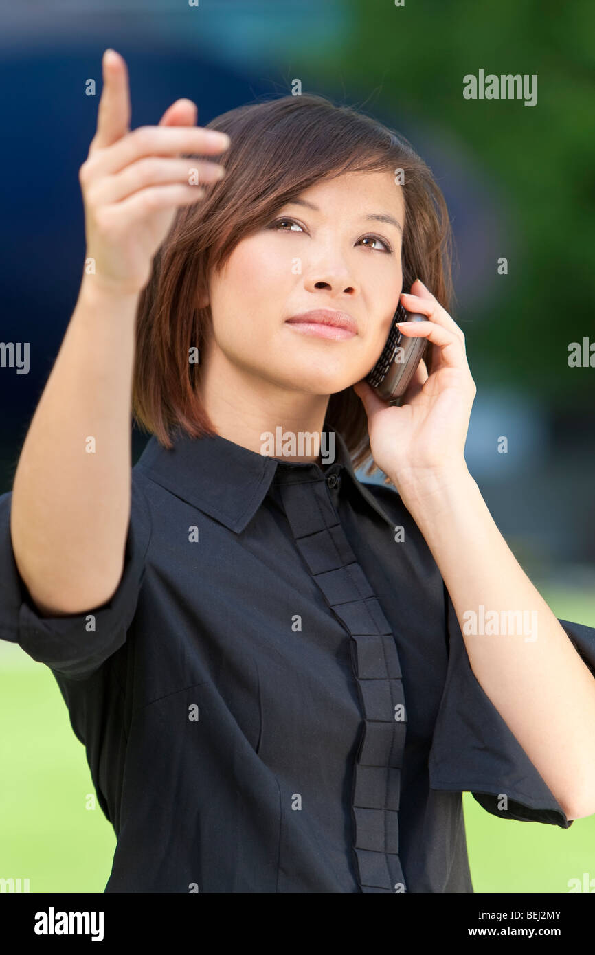 A beautiful young oriental Asian Chinese woman chatting on her cell ...