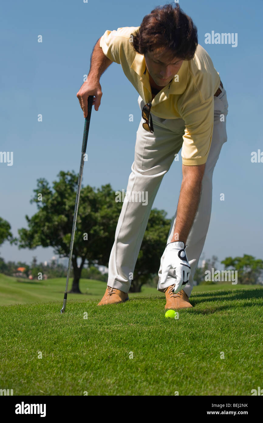 Mid adult man playing golf Stock Photo - Alamy