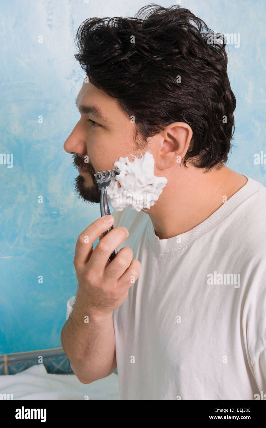 Side profile of a mid adult man shaving Stock Photo - Alamy
