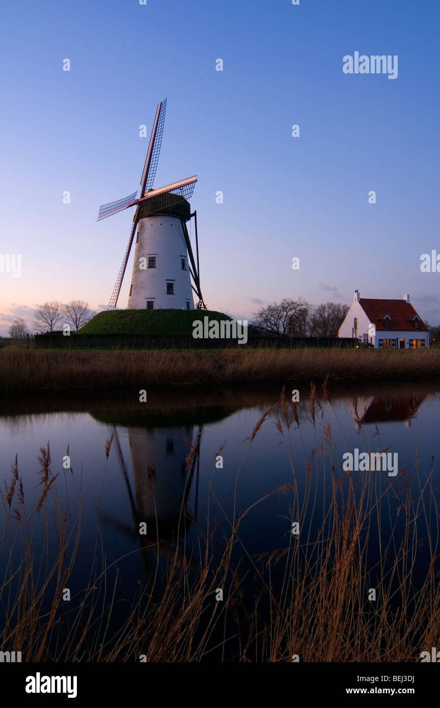 The traditional windmill Schellemolen at sunset along the Damme Canal ...