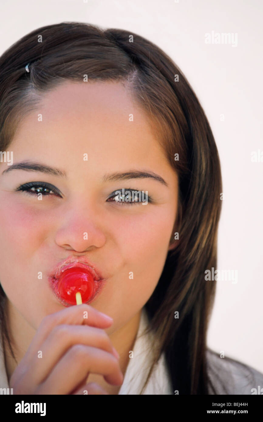 Woman sucking lollipop hi-res stock photography and images - Alamy
