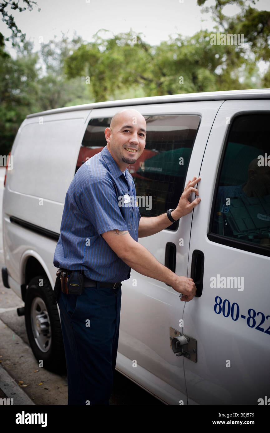 Blue collar worker getting in van Stock Photo - Alamy