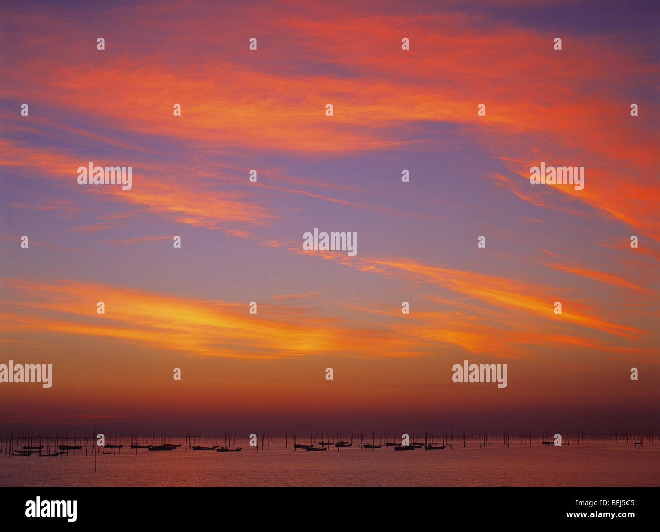 Vivid sunrise over harbour Stock Photo - Alamy