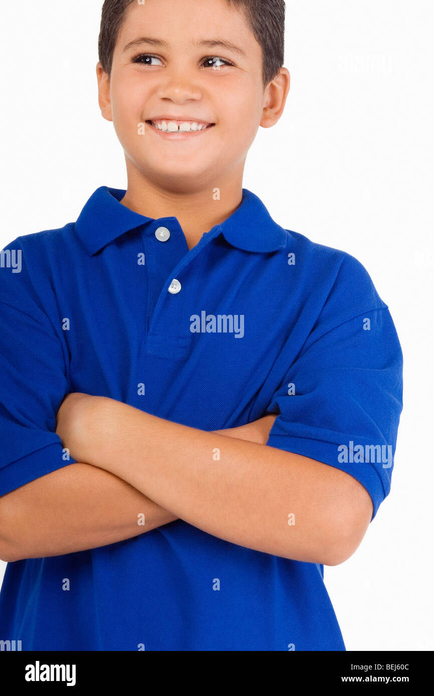 Close-up of a boy standing with his arms crossed and smiling Stock ...