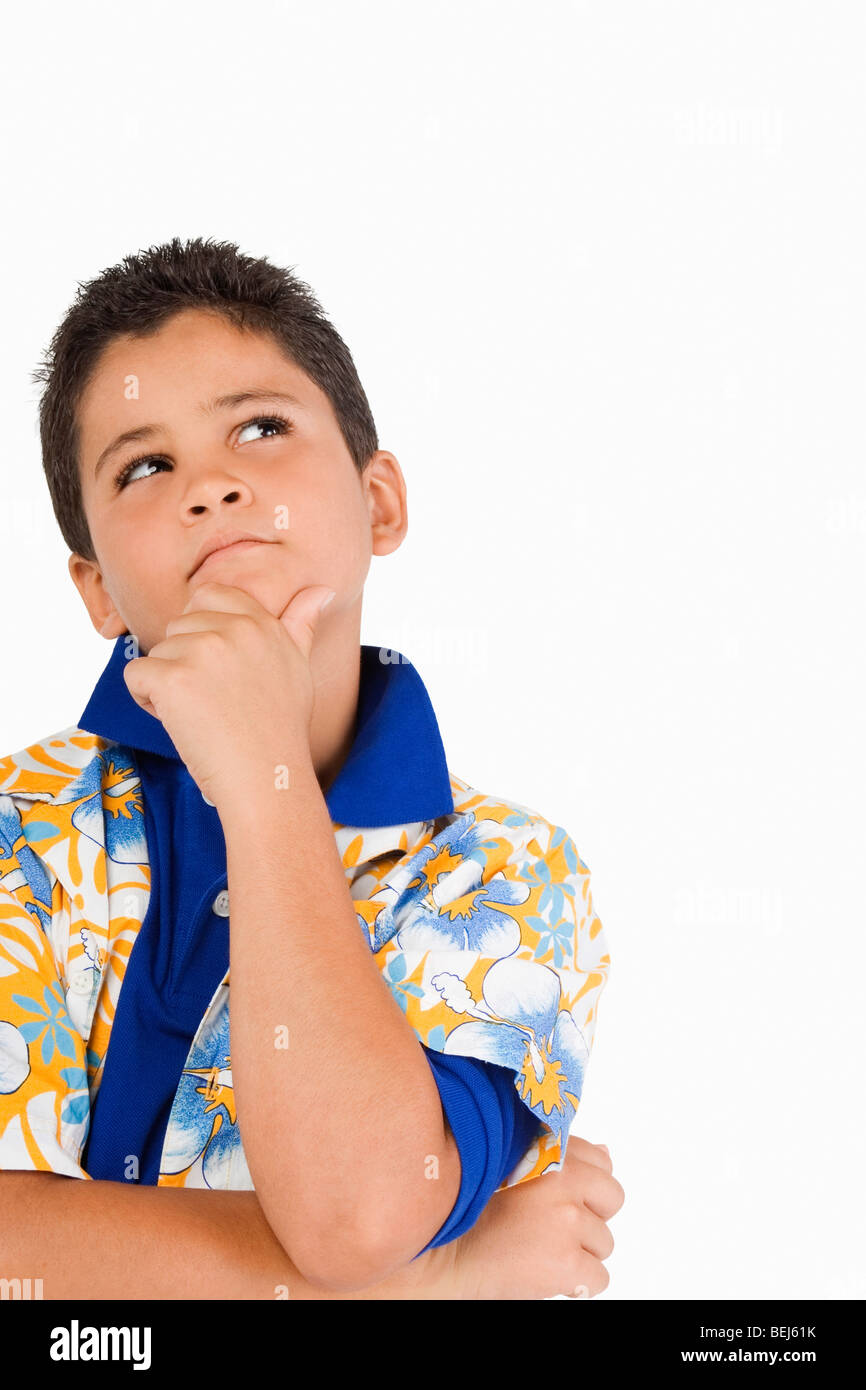 Close-up of a boy thinking with his hand on his chin Stock Photo - Alamy