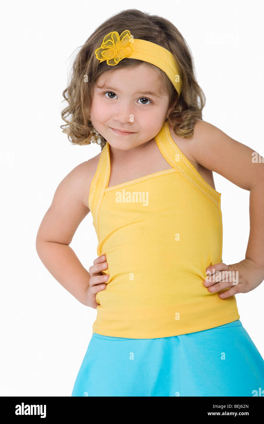 Portrait of a girl standing with arms akimbo Stock Photo - Alamy