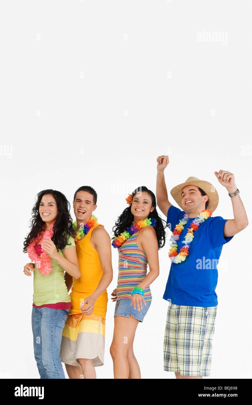 Teenage couple with a young couple standing in a row and smiling Stock ...