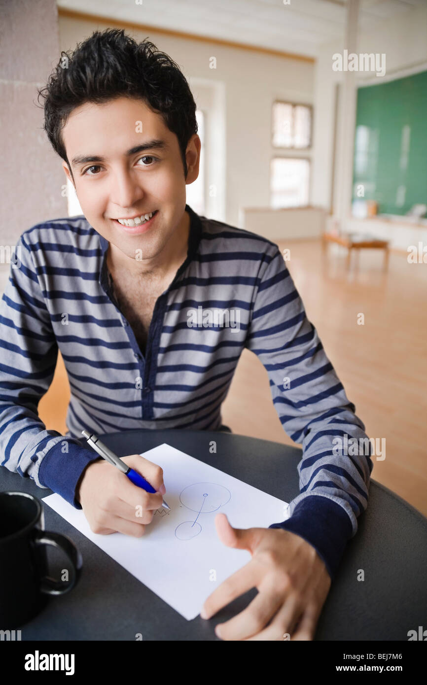 Portrait of a young man drawing on a sheet of paper Stock Photo - Alamy