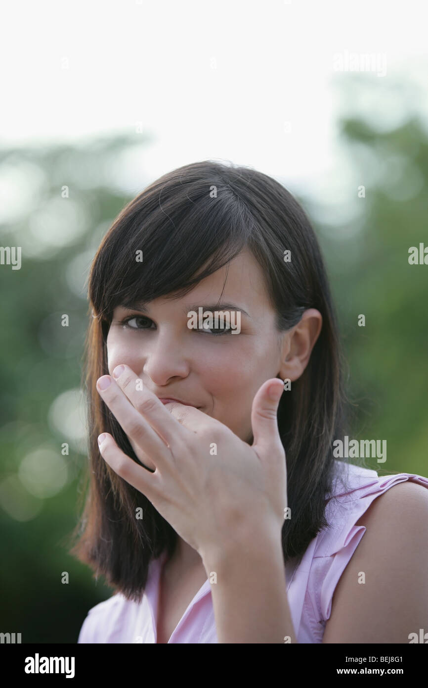 Portrait of a young woman licking her finger Stock Photo - Alamy