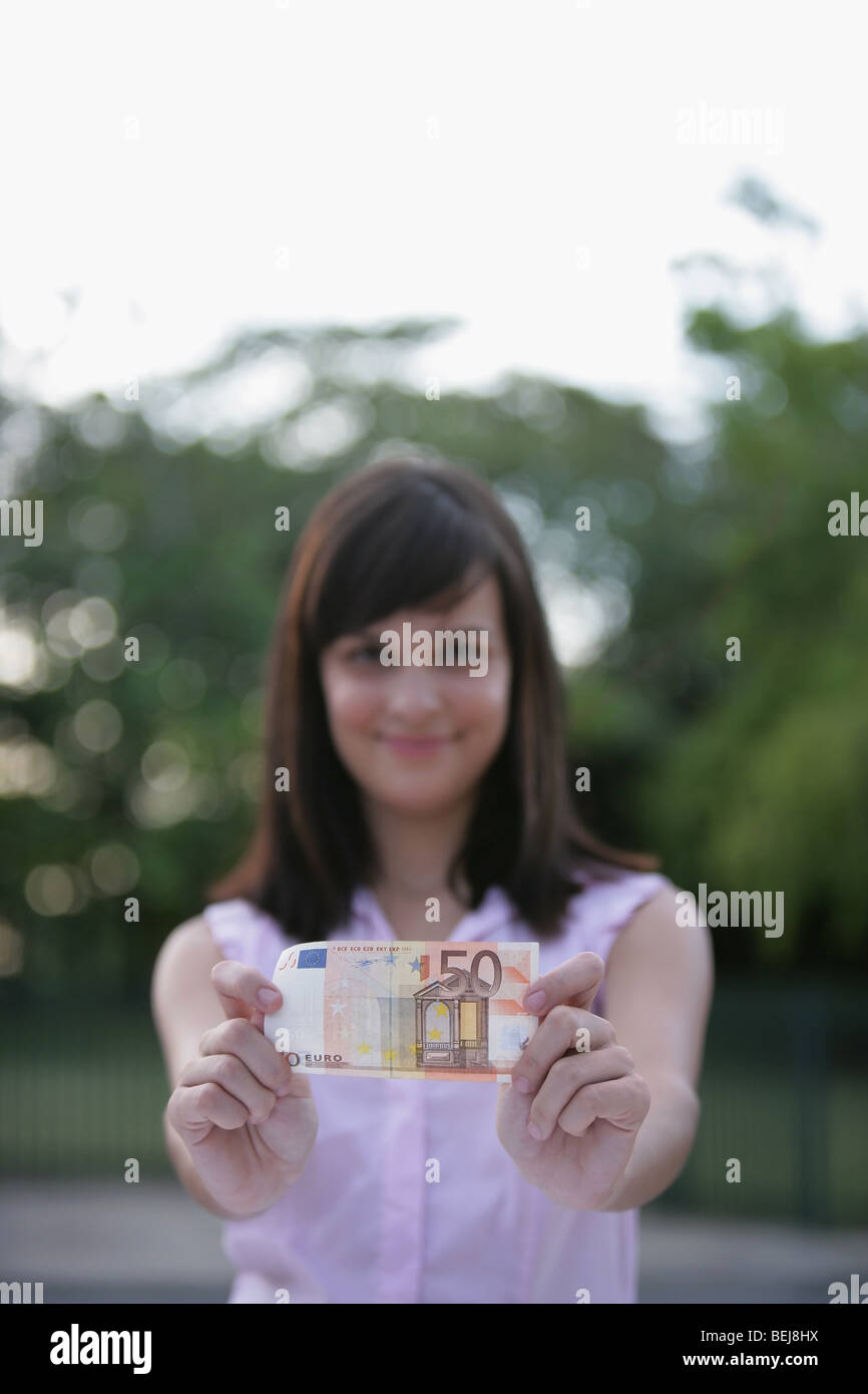 Young woman showing a fifty Euro banknote and smiling Stock Photo - Alamy