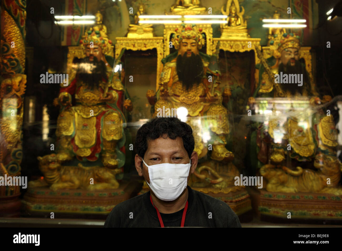 Asian man wears surgical face mask inside a Chinese temple in Bangkok ...