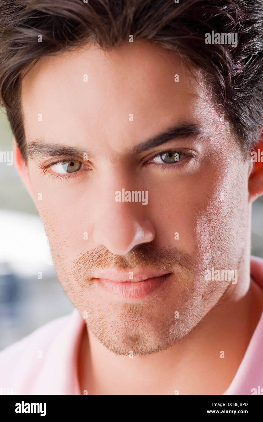 Portrait of a young man looking serious Stock Photo - Alamy