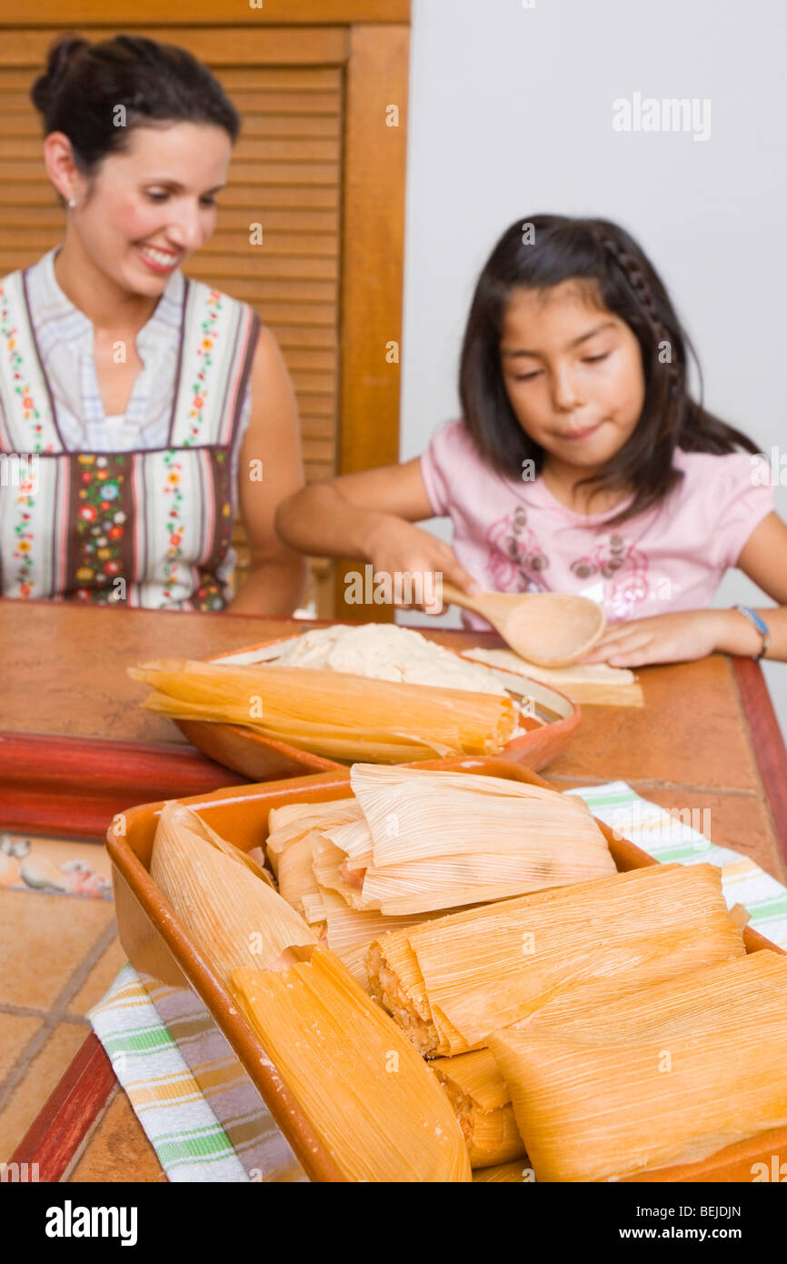 Girl preparing bread with her mother in the kitchen Stock Photo - Alamy
