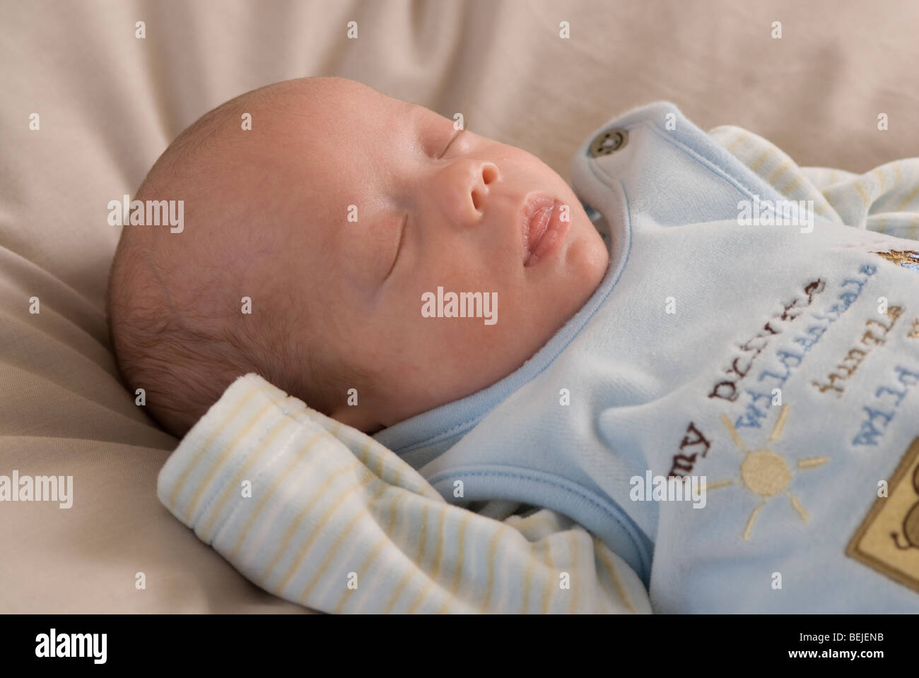 Baby boy peacefully sleeping on a bed, 11 weeks old Stock Photo - Alamy