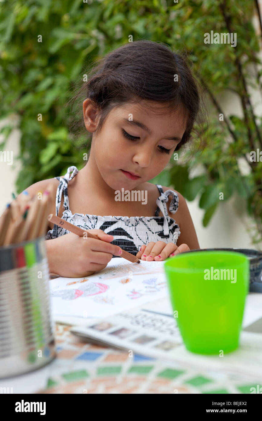 Little girl is coloring a book Stock Photo - Alamy