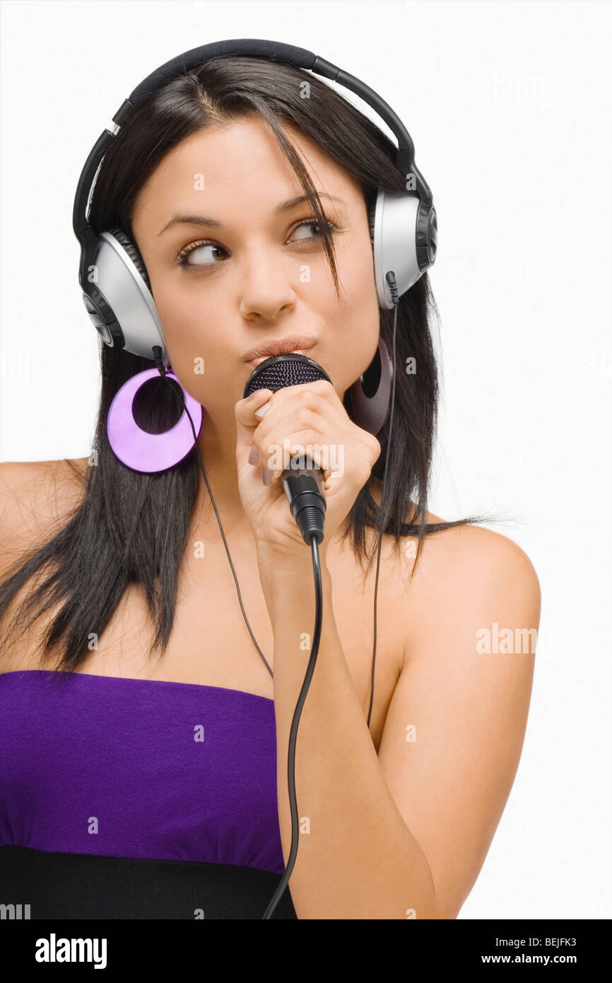 Close-up of a young woman singing into a microphone Stock Photo - Alamy