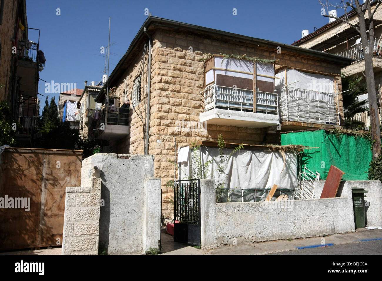 Israel, Jerusalem A building with a Sukkah in the yard and on the ...