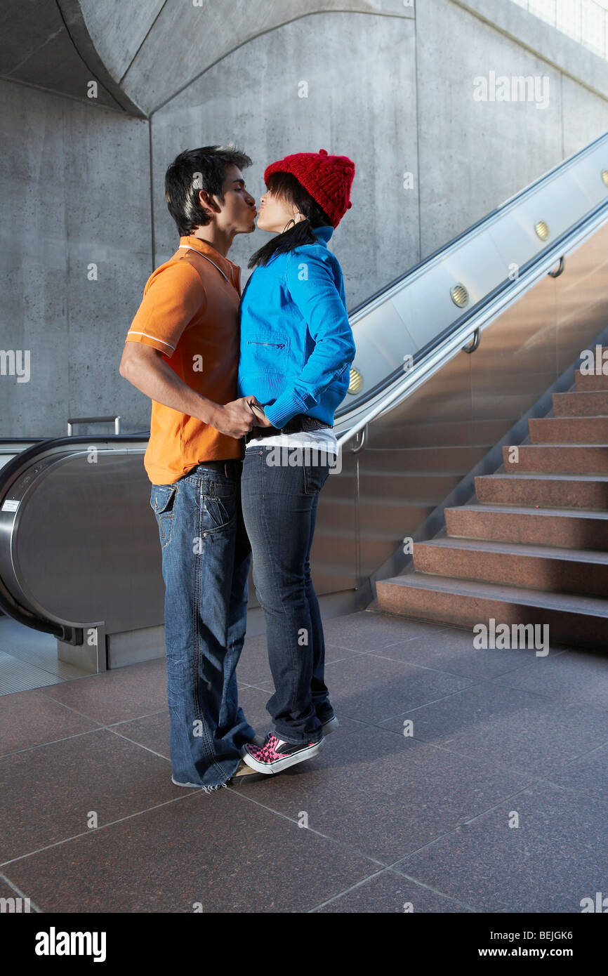 Side profile of a young couple kissing each other Stock Photo - Alamy
