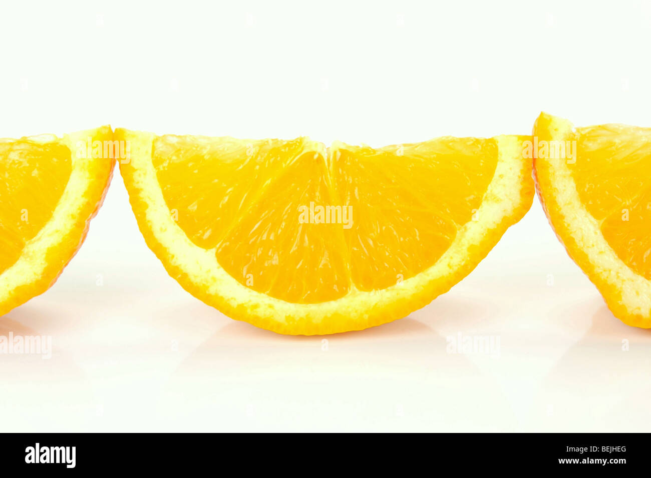 Orange quarters isolated against a white background Stock Photo - Alamy
