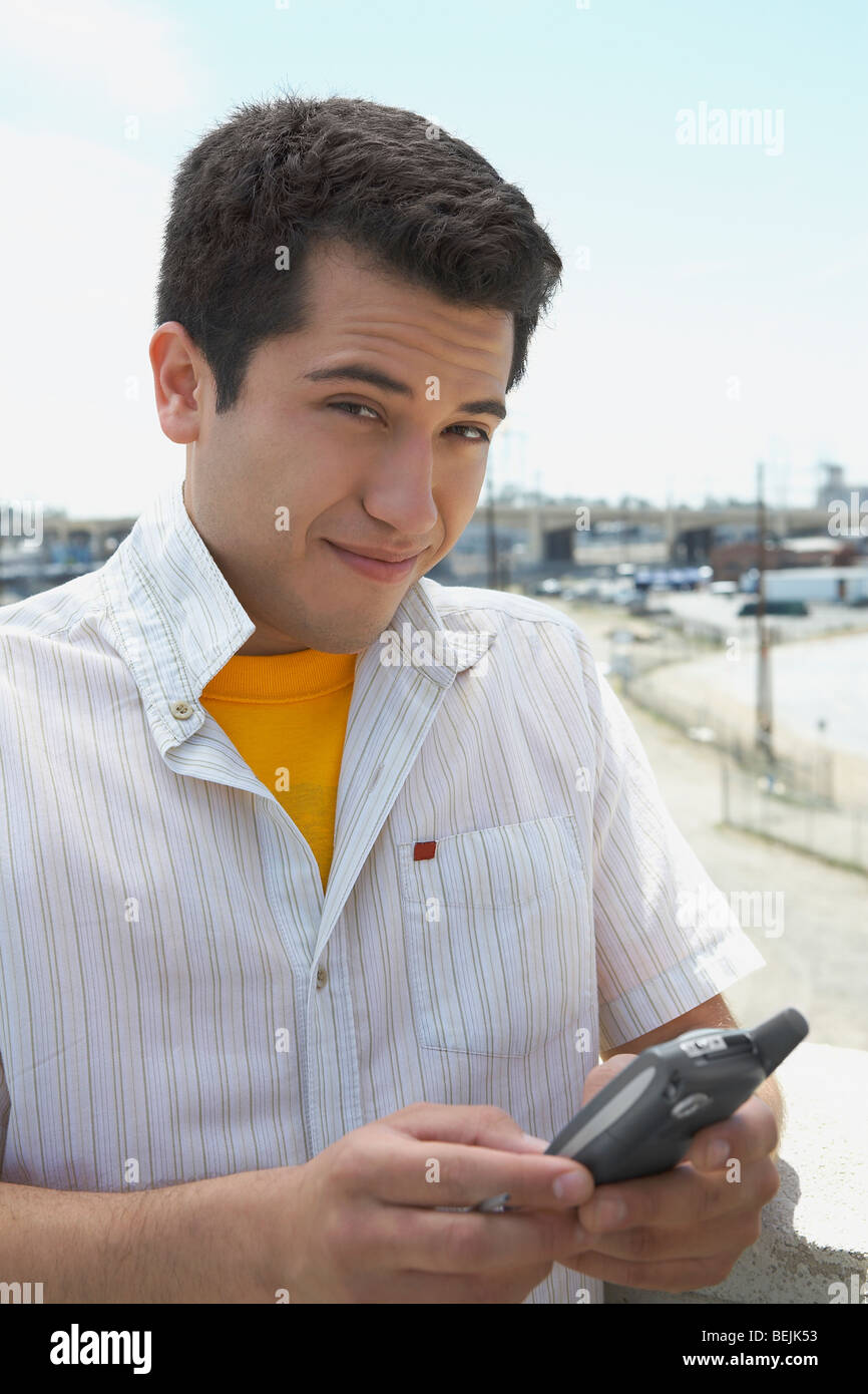Portrait of a young man using a personal data assistant Stock Photo - Alamy