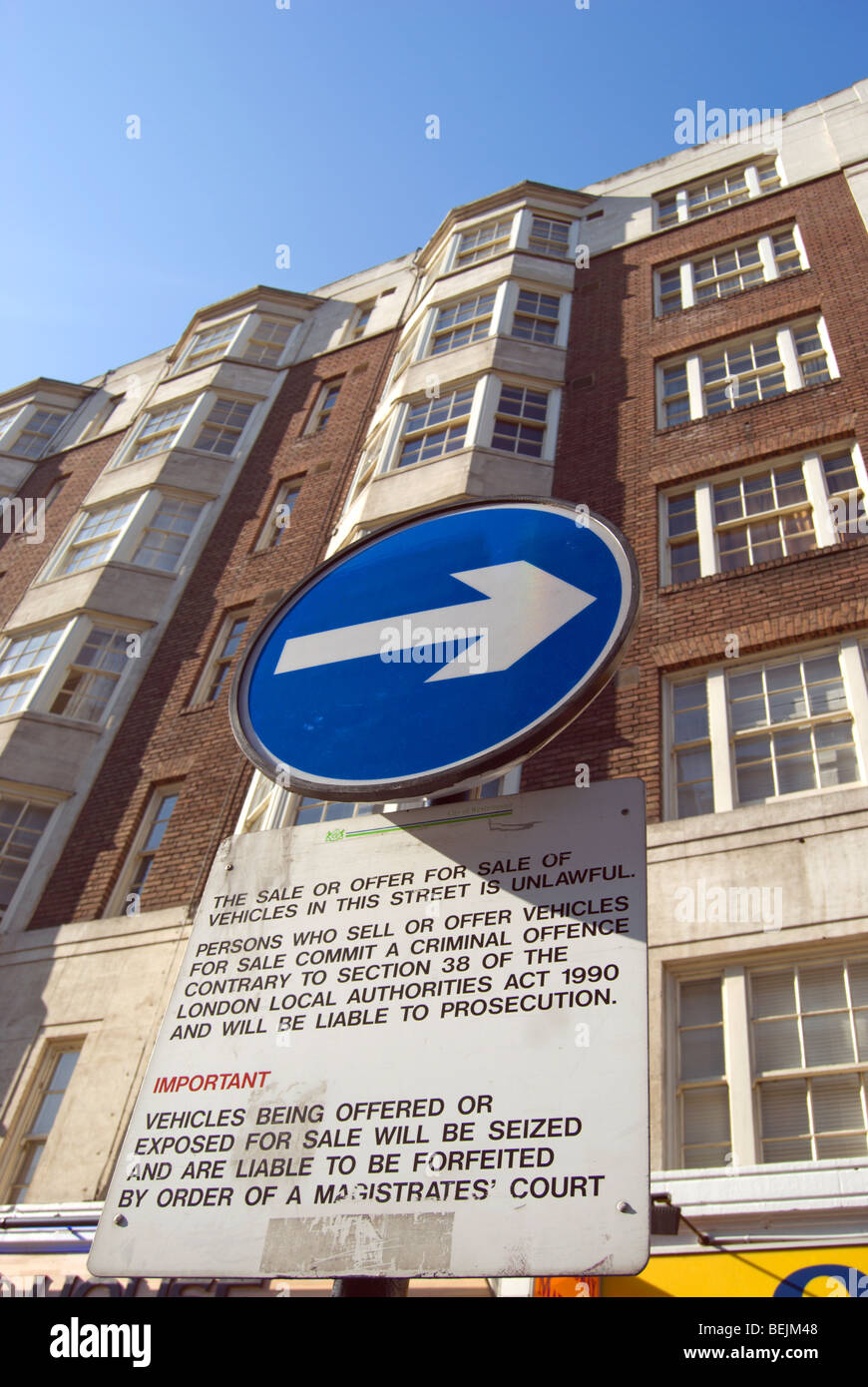 road sign indicating traffic must turn right and notice warning of the ...