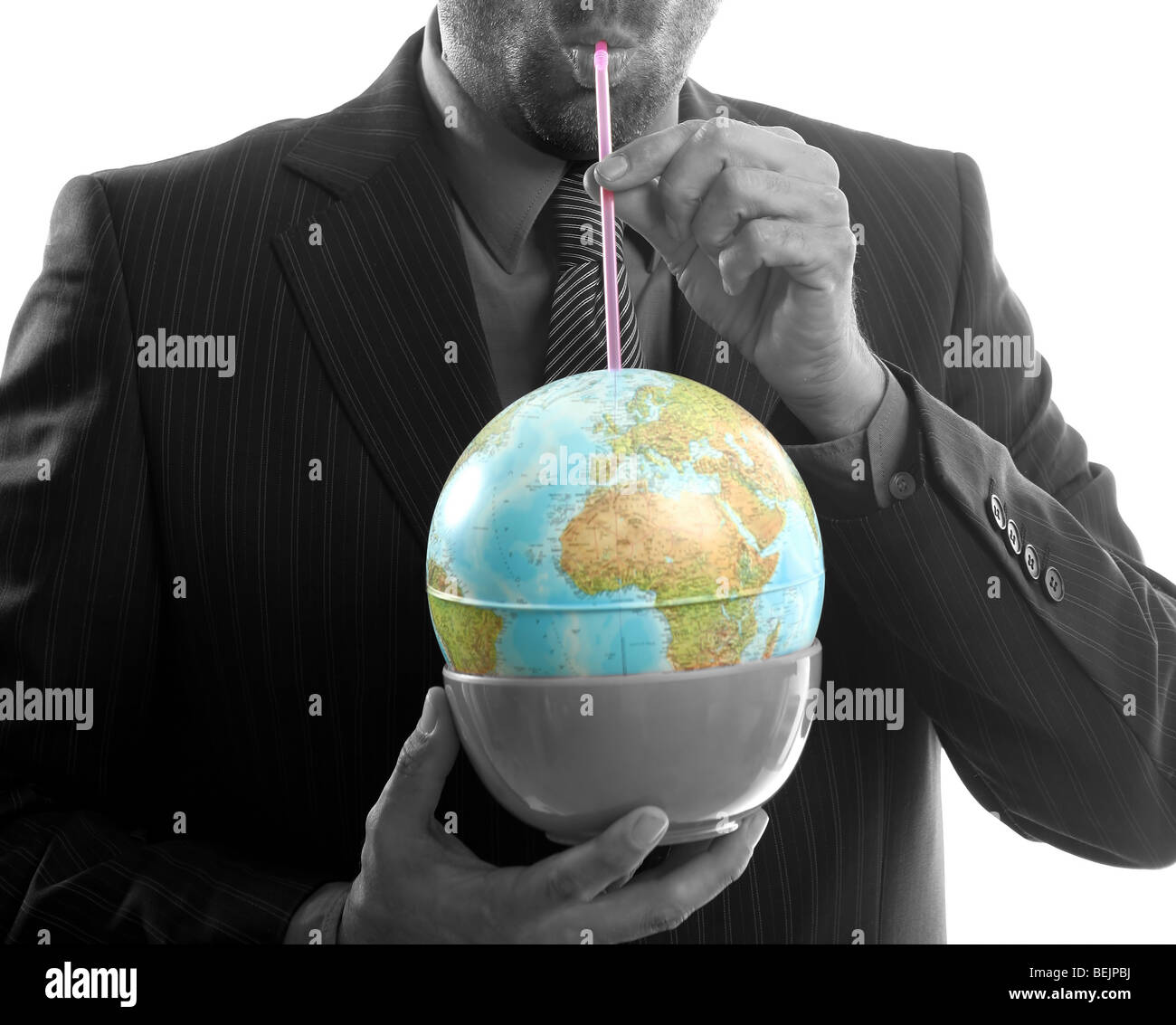 Businessman drinking the world, a power leader metaphor Stock Photo - Alamy